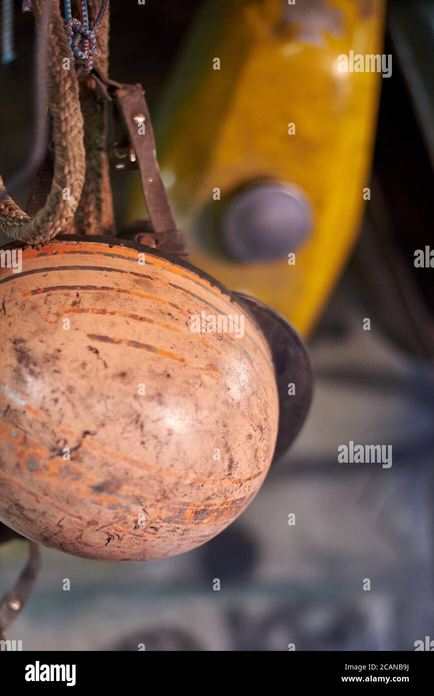 An old vintage scratched motorcycle helmet hangs in a garage Stock ...