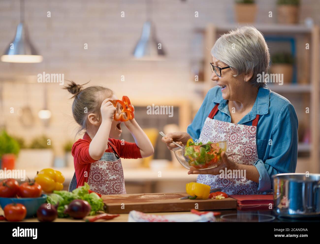 Healthy food at home. Happy family in the kitchen. Grandma and child ...