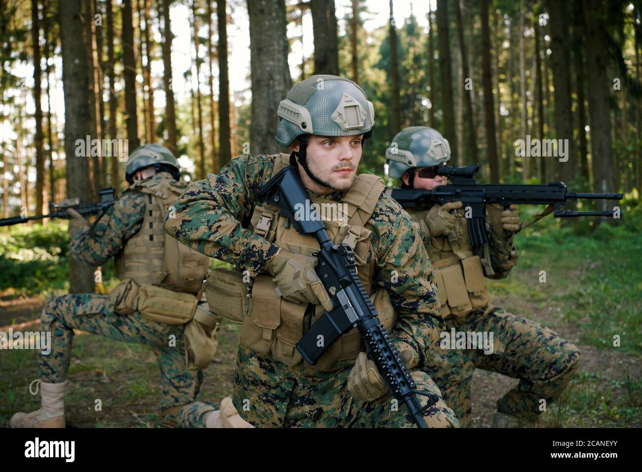 Soldier fighters standing together with guns. Group portrait of US army ...