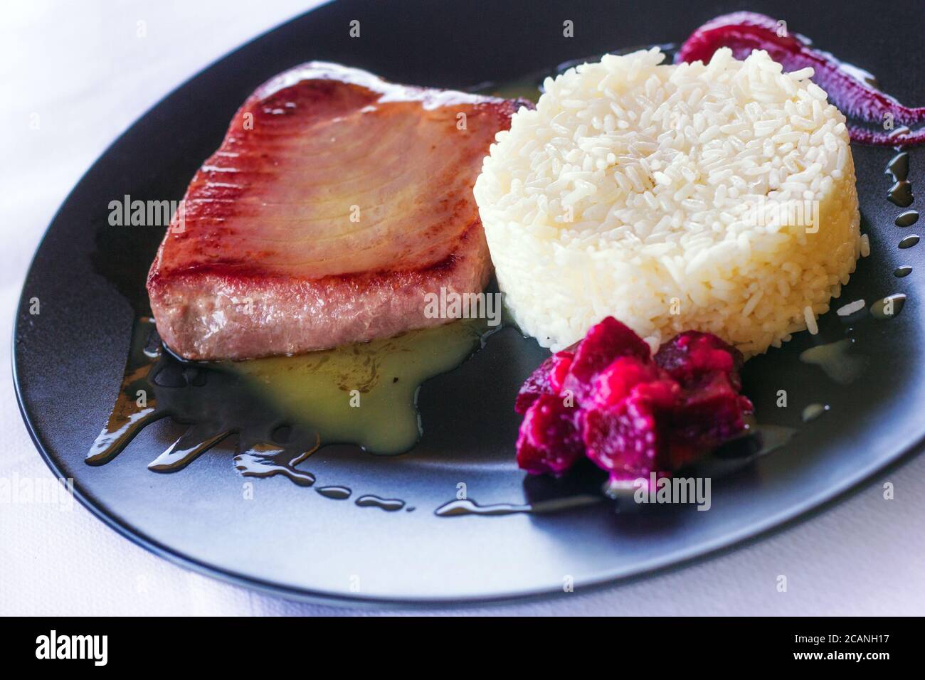 Fresh Naxian tuna steak sauteed in olive oil, with rice and beet puree ...