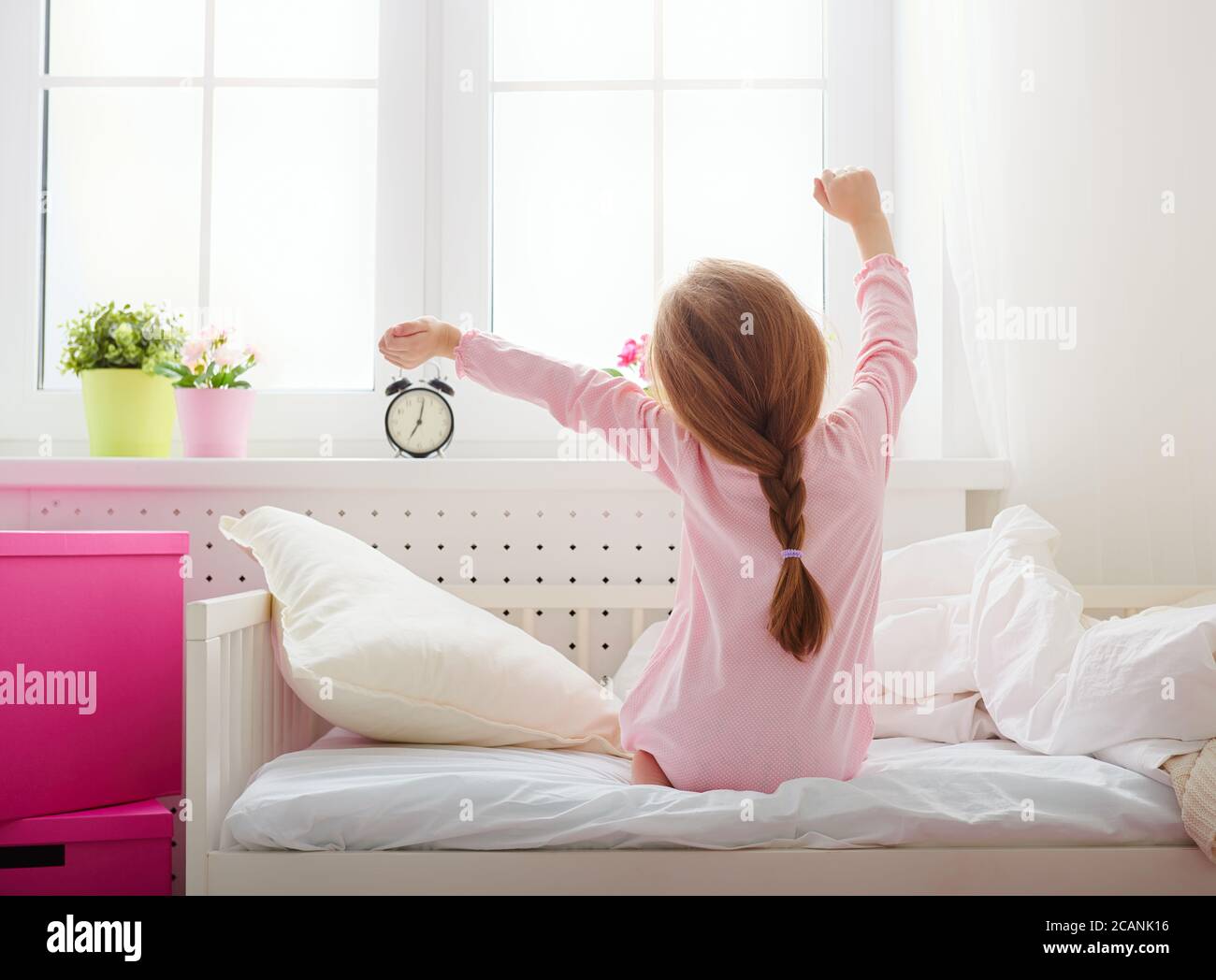 A nice child girl enjoys sunny morning. Good morning at home. Child ...