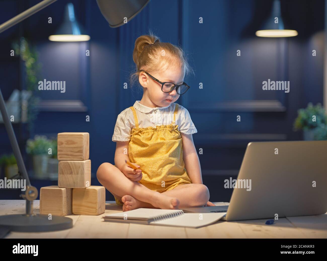 Cute baby girl working on a computer at home Stock Photo - Alamy