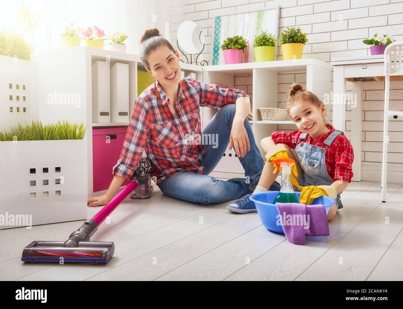 Happy family cleans the room. Mother and daughter do the cleaning in ...