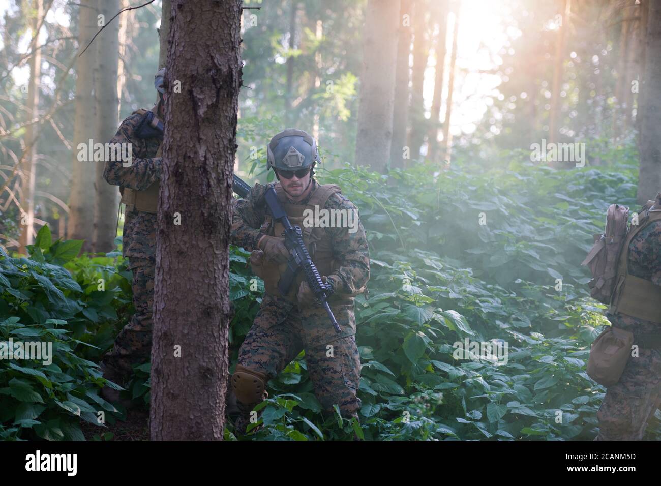 modern warfare soldier in action aiming on laser sight optics in combat ...
