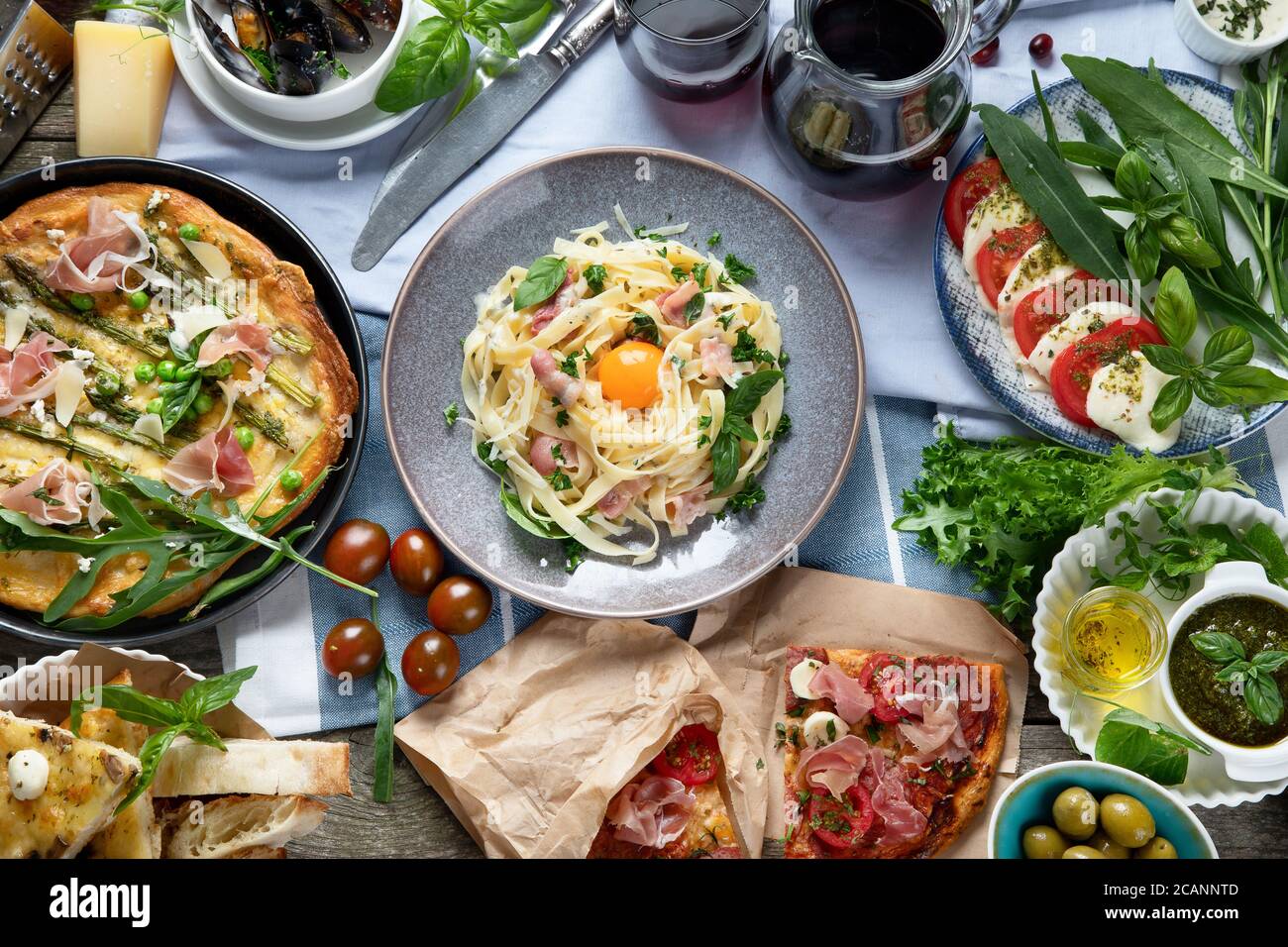 Appetizing classic Italian cuisine on rustic wooden table. Different ...