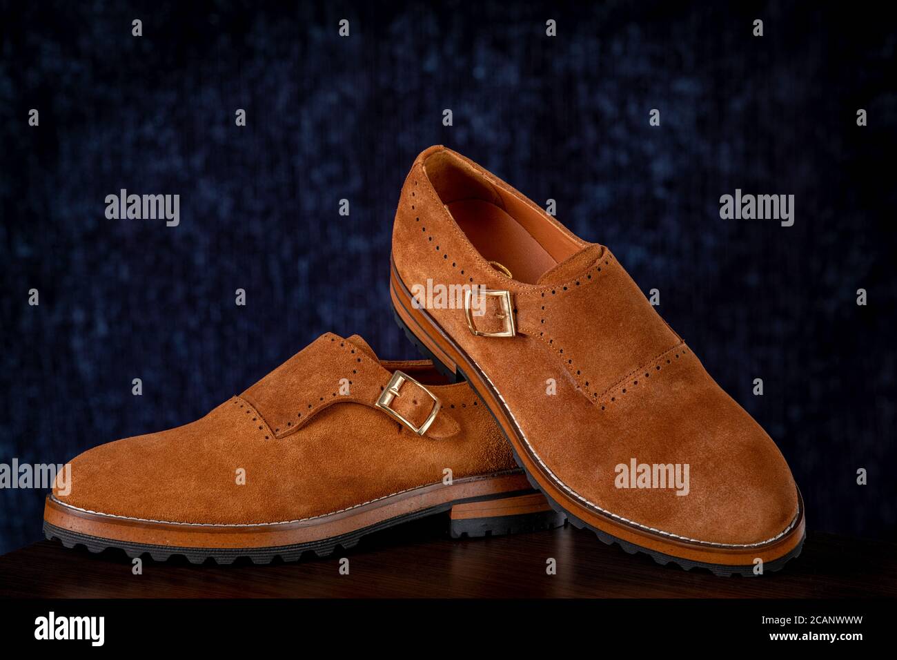 Brown men's lather shoes on blue background Stock Photo - Alamy