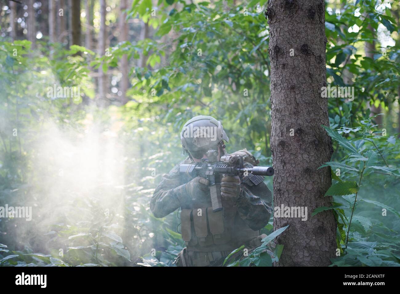modern warfare soldier in action aiming at weapon laser sight optics in ...
