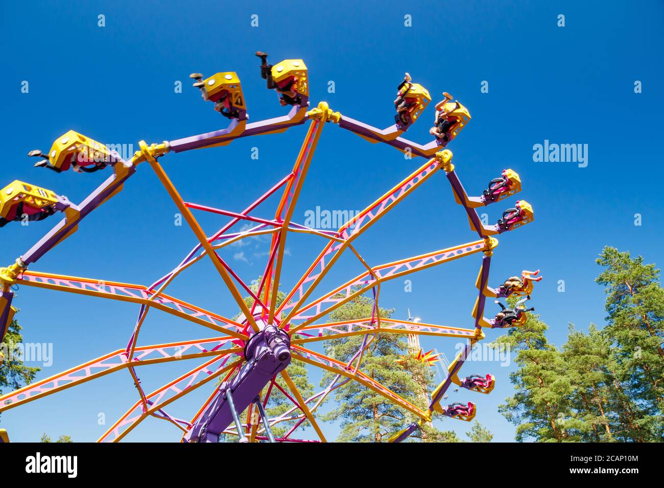 Extreme ride in motion in amusement park at sunny day Stock Photo - Alamy