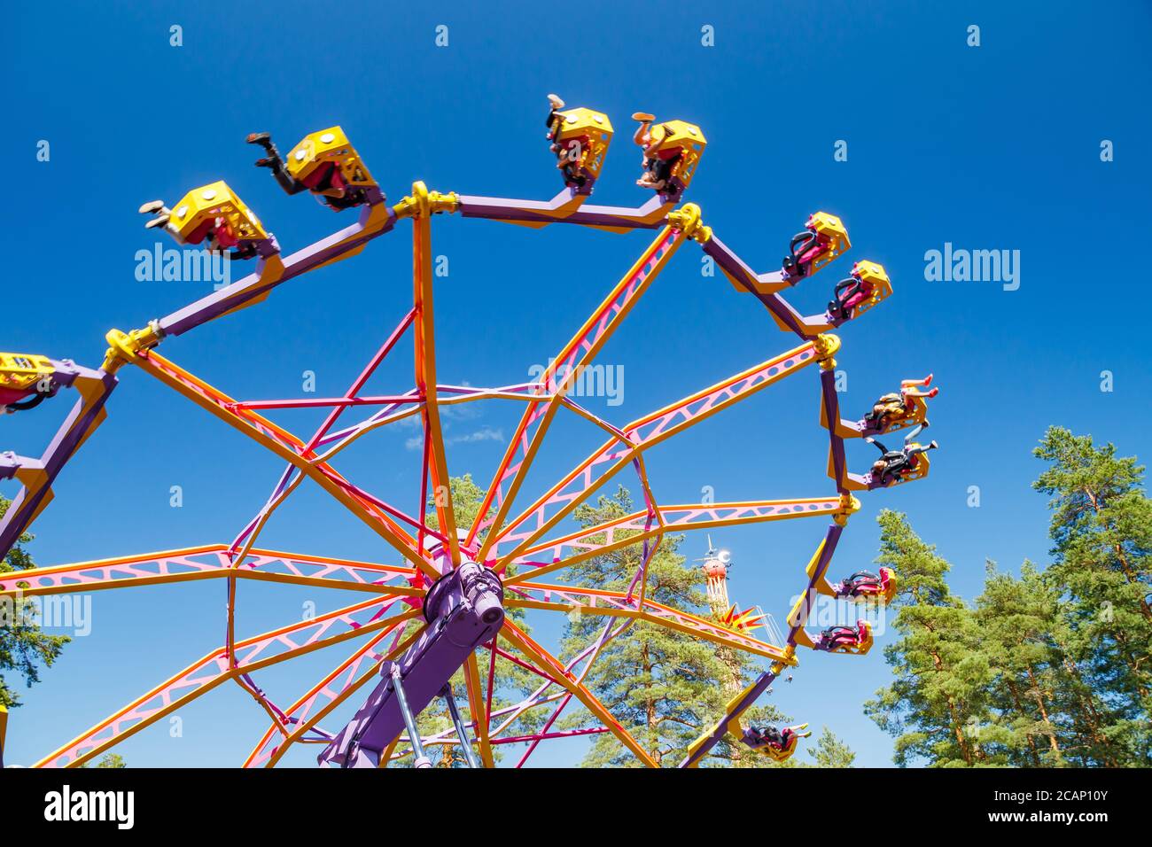 Extreme ride in motion in amusement park at sunny day Stock Photo - Alamy