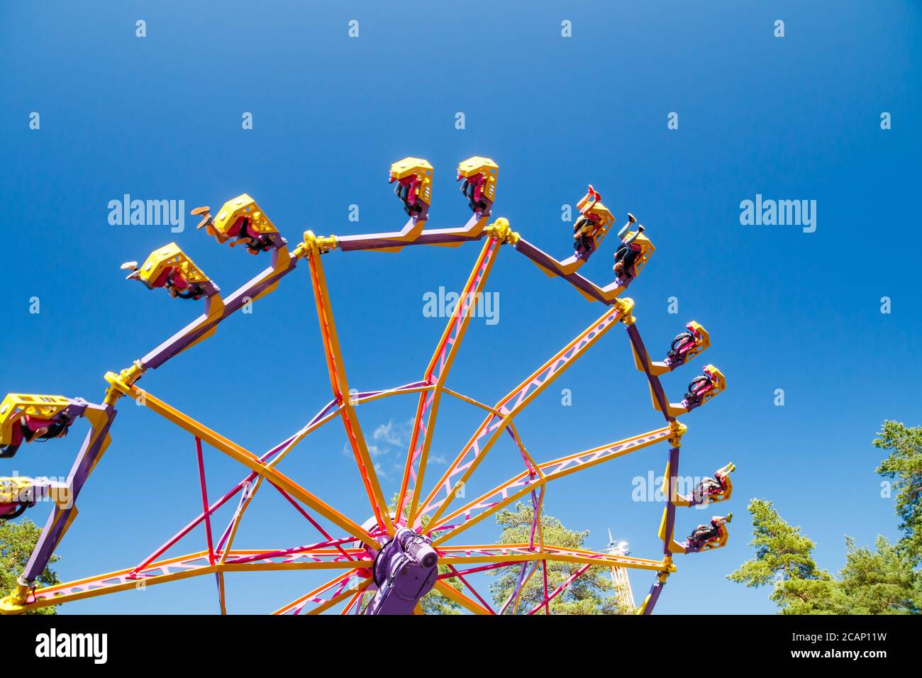 Extreme ride in motion in amusement park at sunny day Stock Photo - Alamy