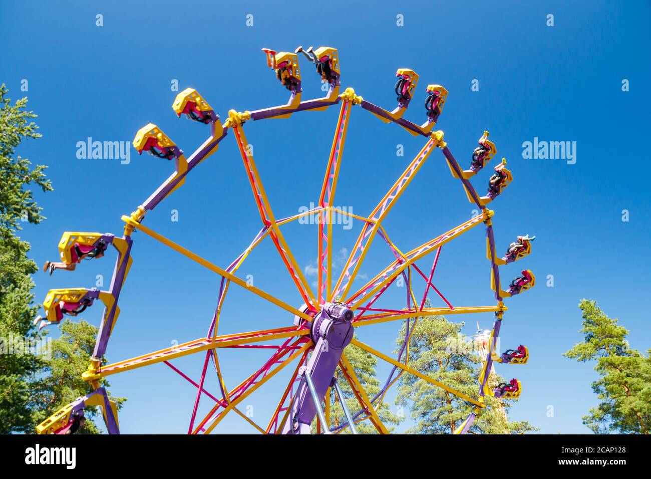 Extreme ride in motion in amusement park at sunny day Stock Photo - Alamy