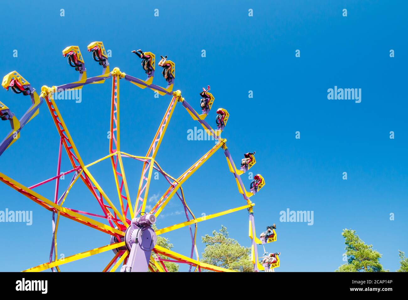 Extreme ride in motion in amusement park at sunny day Stock Photo - Alamy