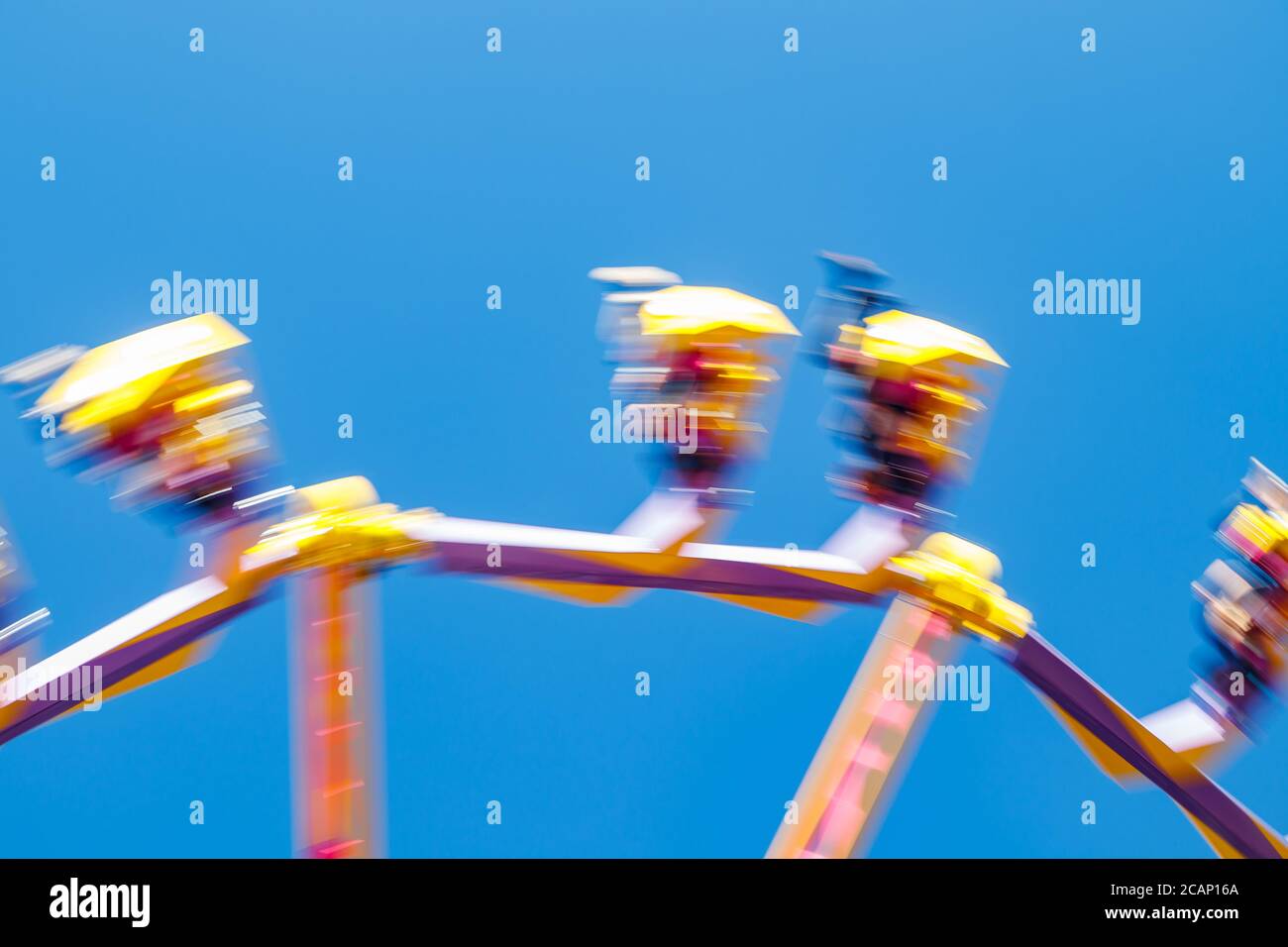 Extreme ride in motion in amusement park at sunny day Stock Photo - Alamy