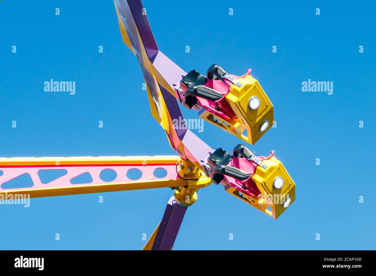 Extreme ride in motion in amusement park at sunny day Stock Photo - Alamy
