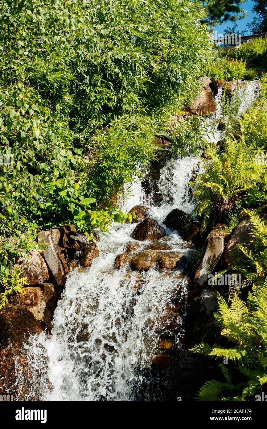 Waterfall in the park at sunny summer day Stock Photo - Alamy