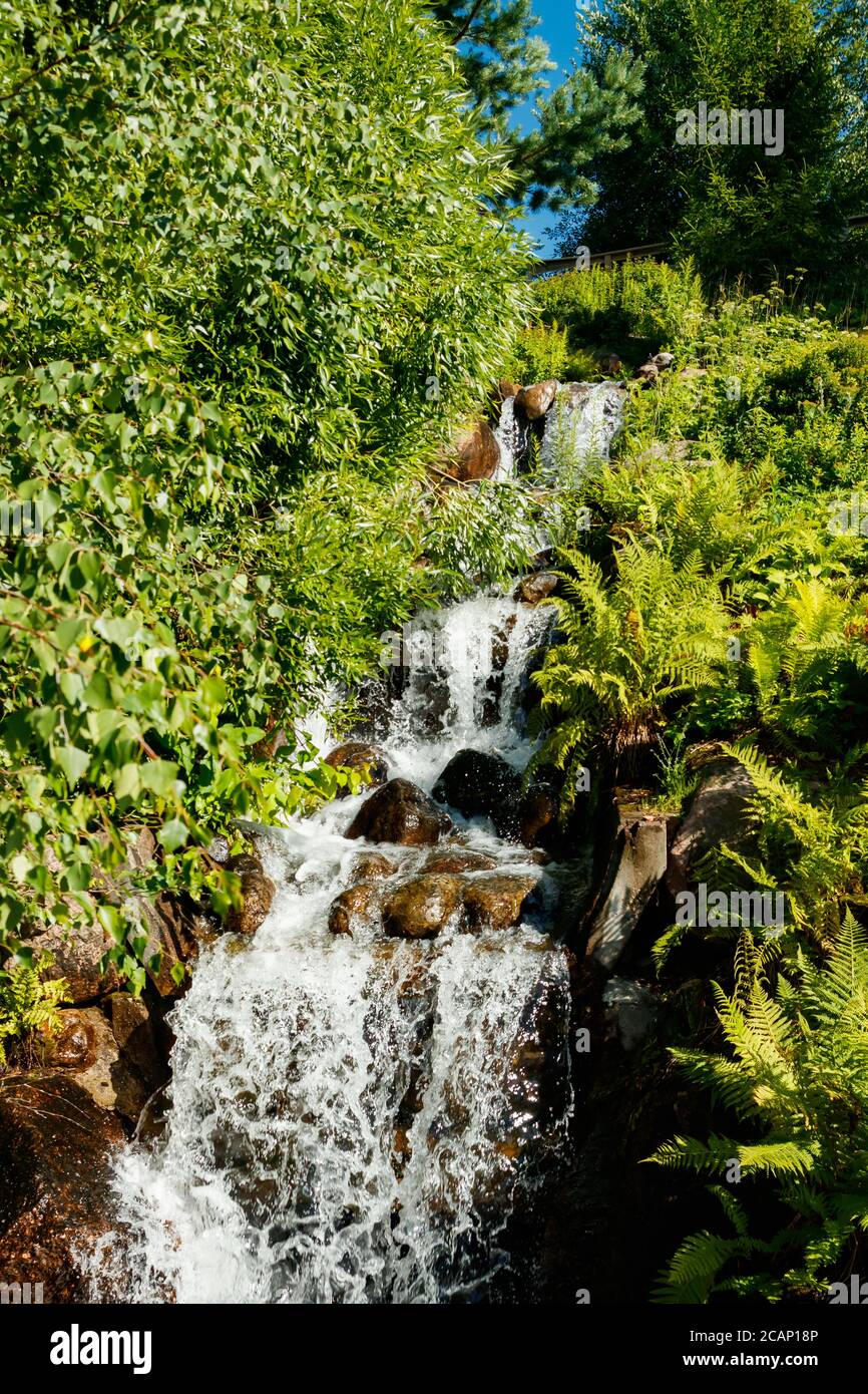 Waterfall in the park at sunny summer day Stock Photo - Alamy