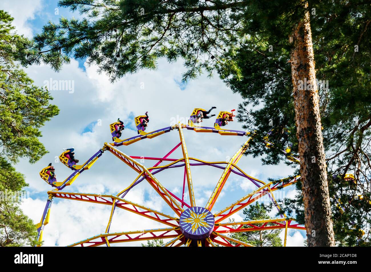 Extreme ride in motion in amusement park at sunny day Stock Photo - Alamy