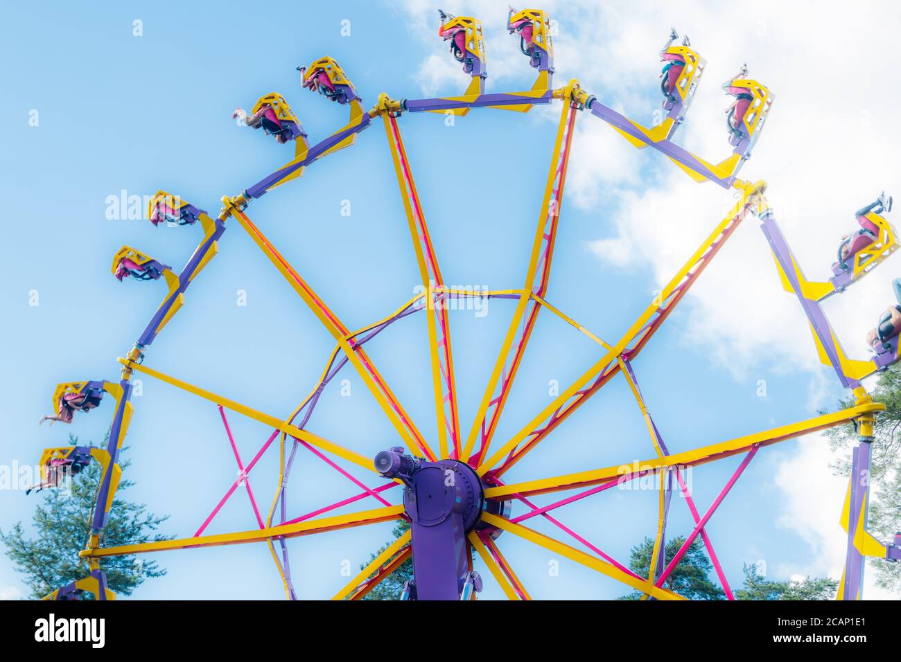Extreme ride in motion in amusement park at sunny day Stock Photo - Alamy