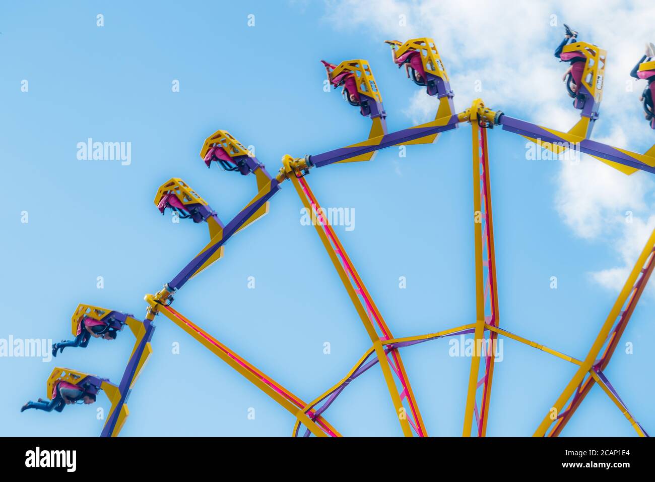 Extreme ride in motion in amusement park at sunny day Stock Photo - Alamy