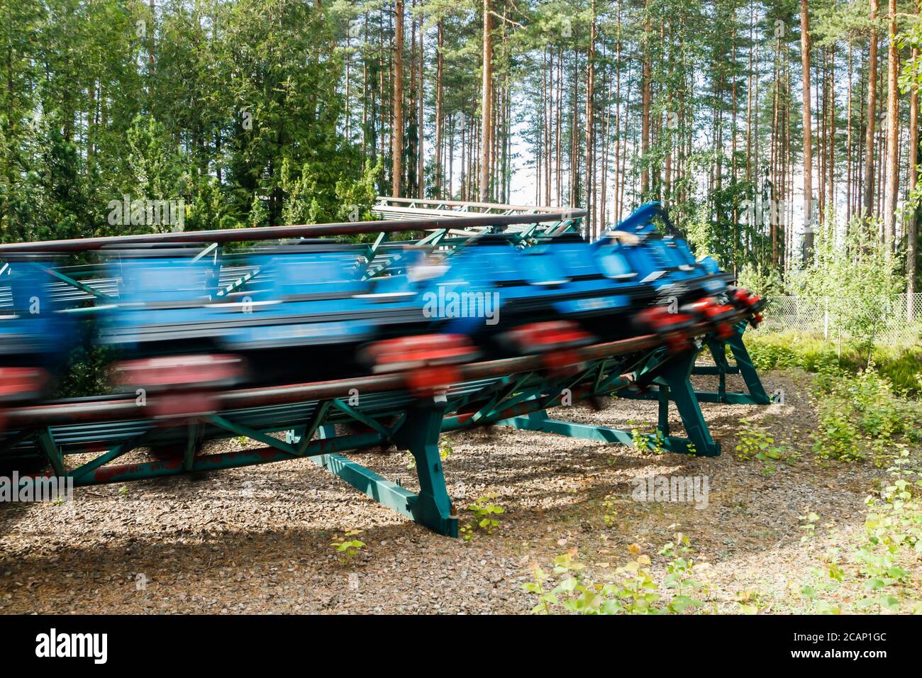 Ride Roller coaster in motion in amusement park at summer day Stock ...