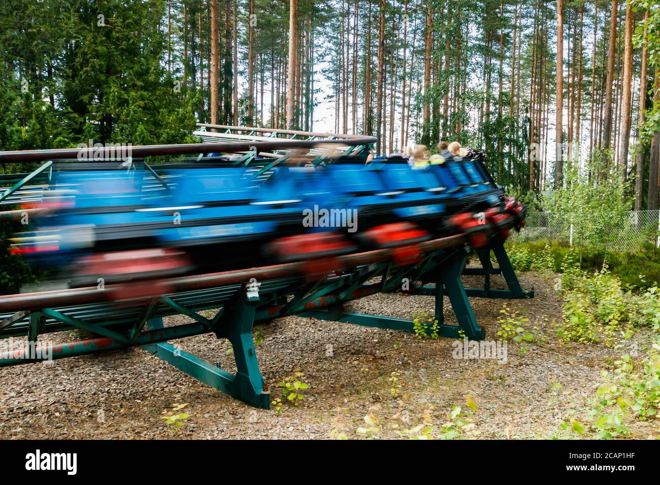 Ride Roller coaster in motion in amusement park at summer day Stock ...