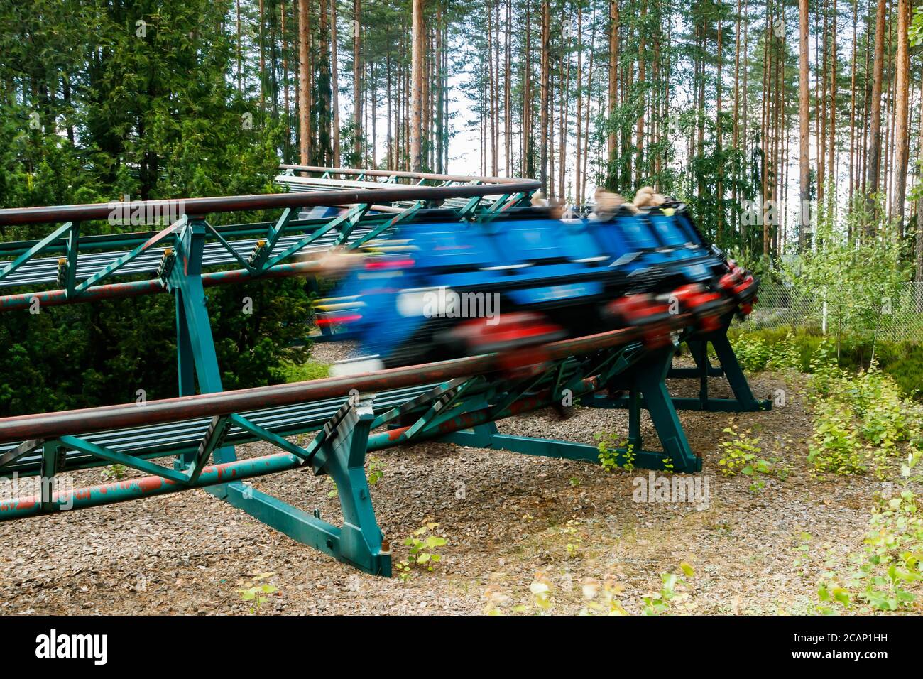 Ride Roller coaster in motion in amusement park at summer day Stock ...