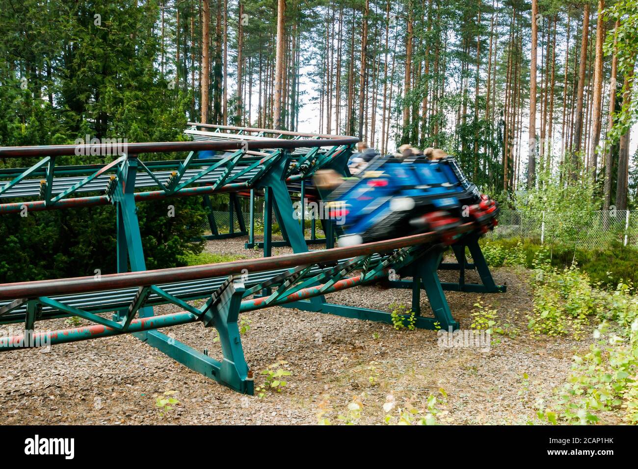 Ride Roller coaster in motion in amusement park at summer day Stock ...