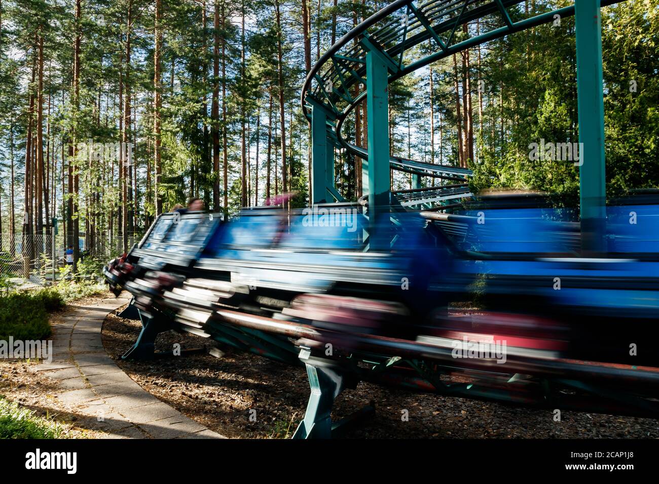 Ride Roller coaster in motion in amusement park at summer day Stock ...