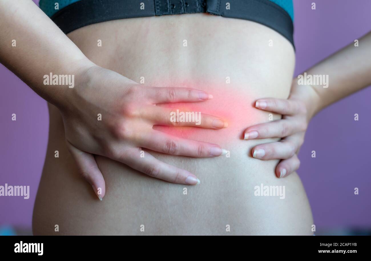 young woman holding red inflamed back , back ache or back injury Stock ...