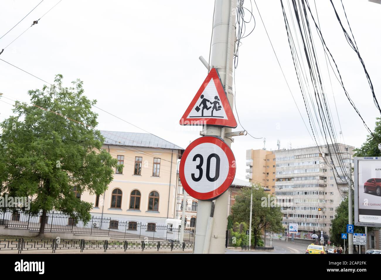 Traffic signs on the pole. For speed limit and attention to children ...