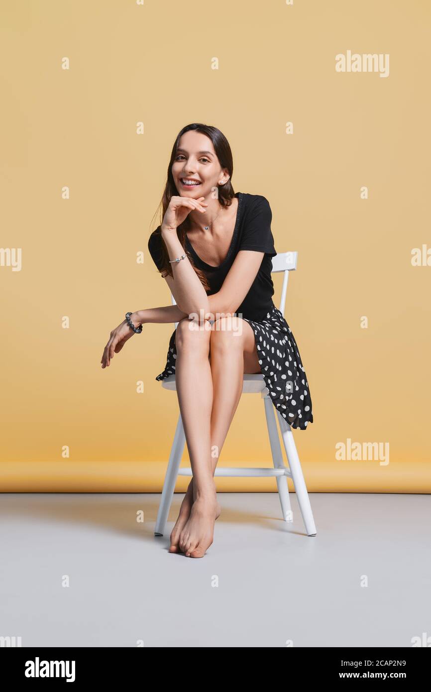 Woman one leg up on chair hi-res stock photography and images - Alamy