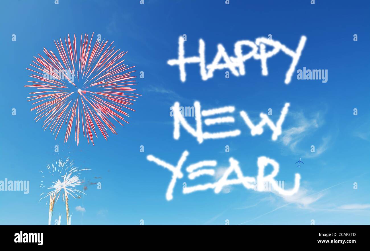 "happy new year" written in a blue sky with fireworks Stock Photo - Alamy