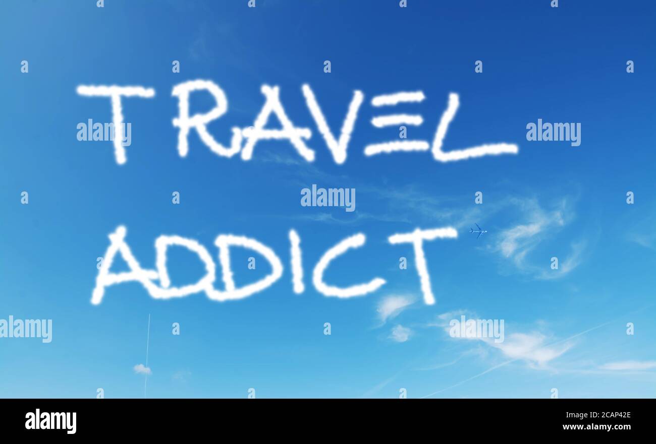 "travel addict" written in a blue sky with fireworks Stock Photo - Alamy