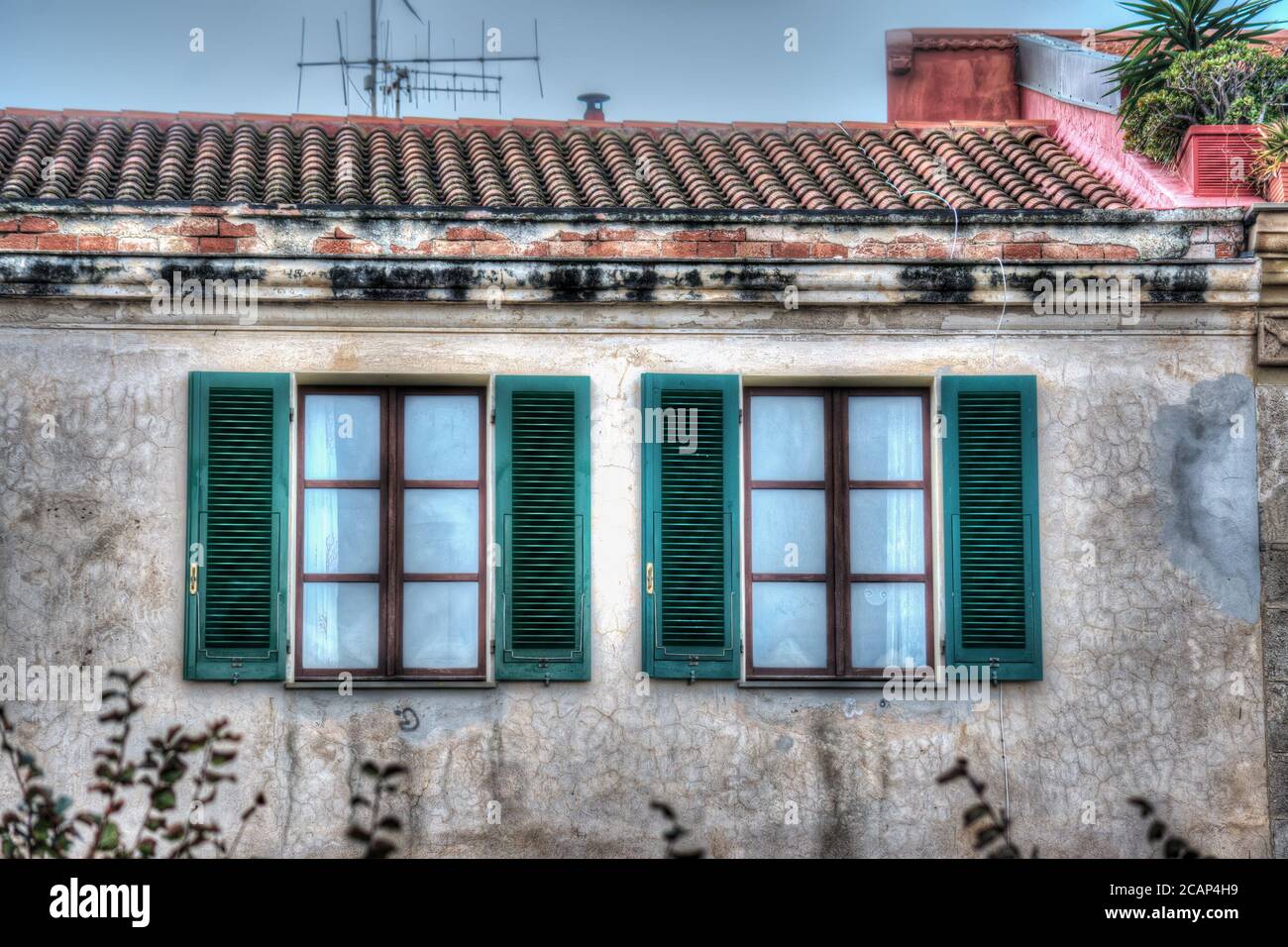 old windows in a rustic wall. Processed for hdr tone mapping effect ...