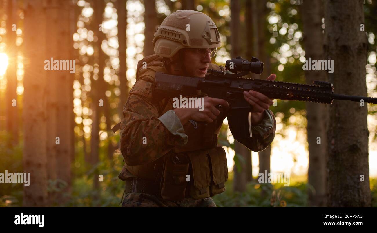 modern warfare soldier in action aiming at weapon laser sight optics in ...