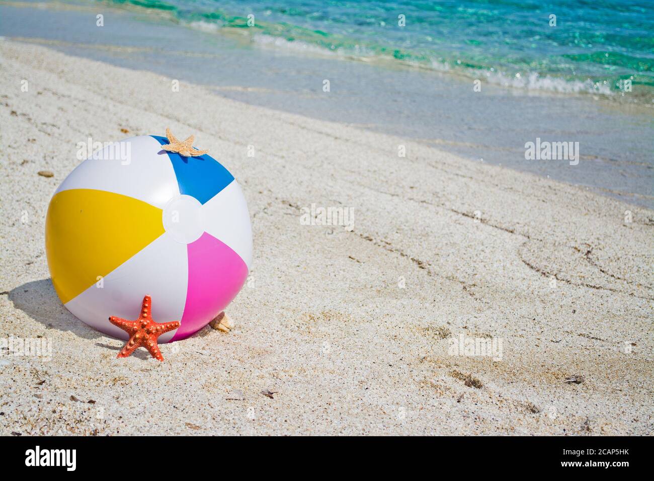 beach ball with starfish by the shore Stock Photo - Alamy