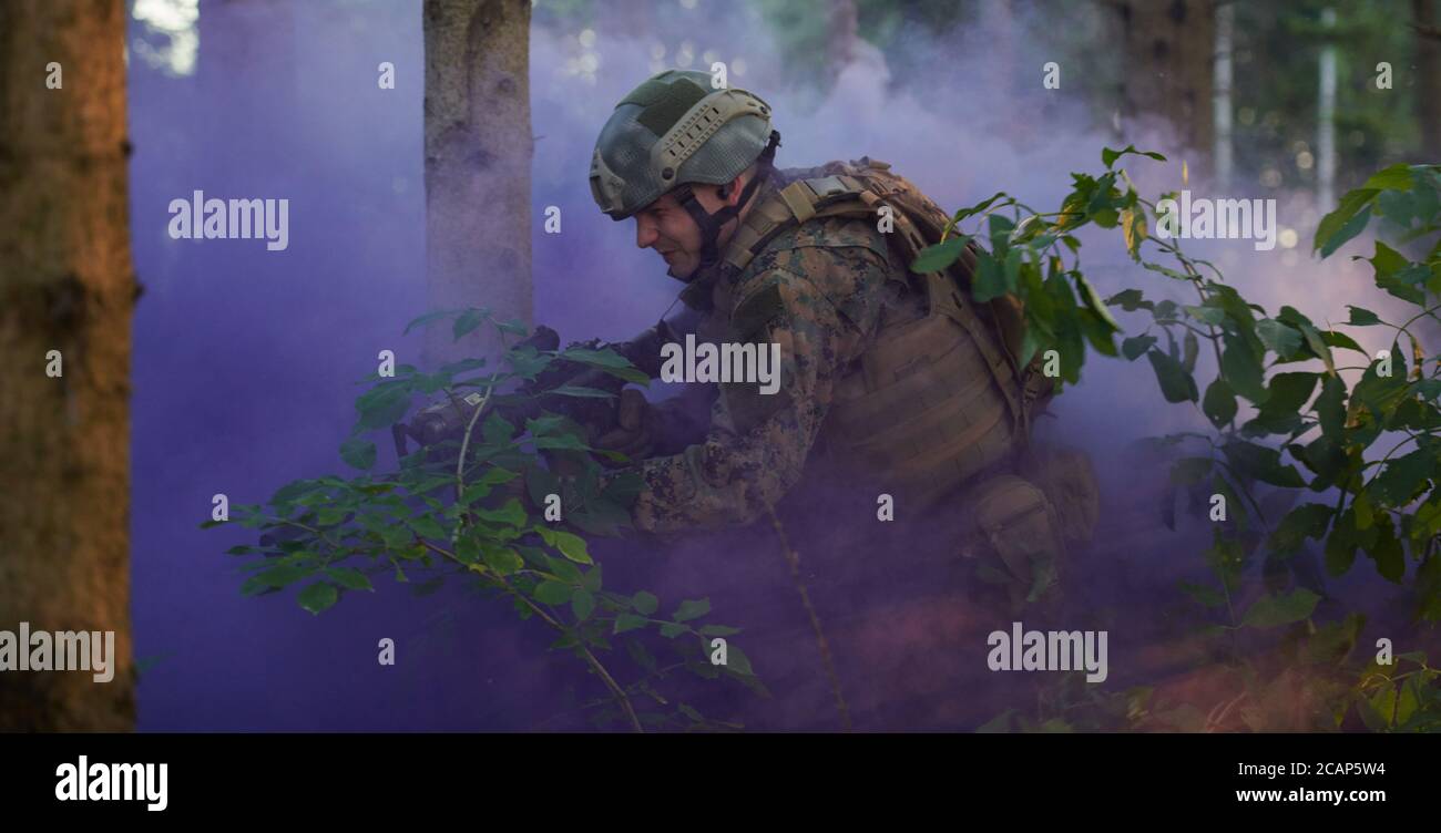 modern warfare soldier in action aiming at weapon laser sight optics in ...