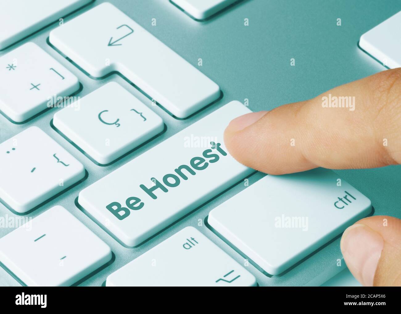 Be Honest Written on Blue Key of Metallic Keyboard. Finger pressing key ...