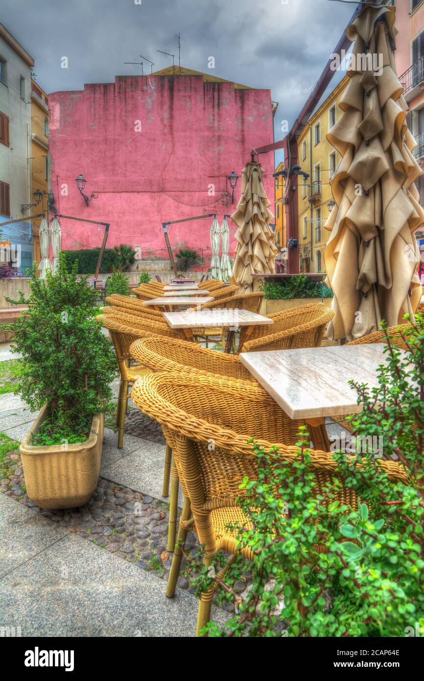 tables and chairs in a small italian square. Processed for hdr tone ...