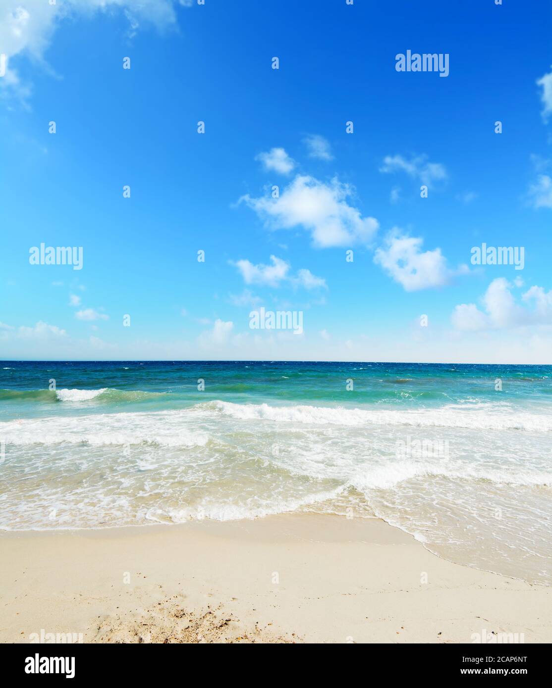 Poetto beach under a blue sky with clouds Stock Photo - Alamy