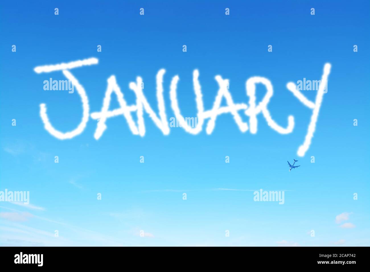 january written in the sky with contrails Stock Photo - Alamy