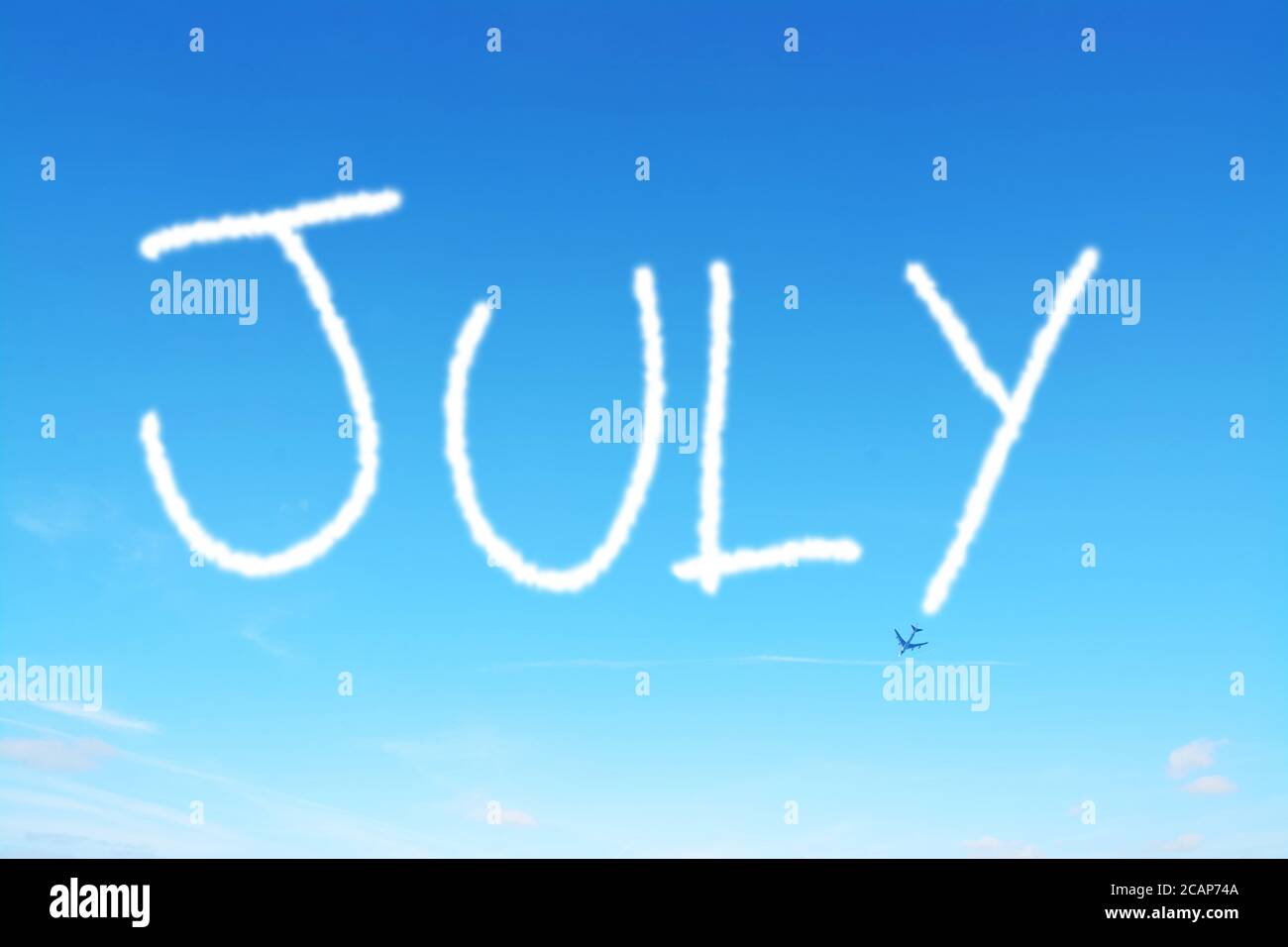 july written in the sky with contrails Stock Photo - Alamy