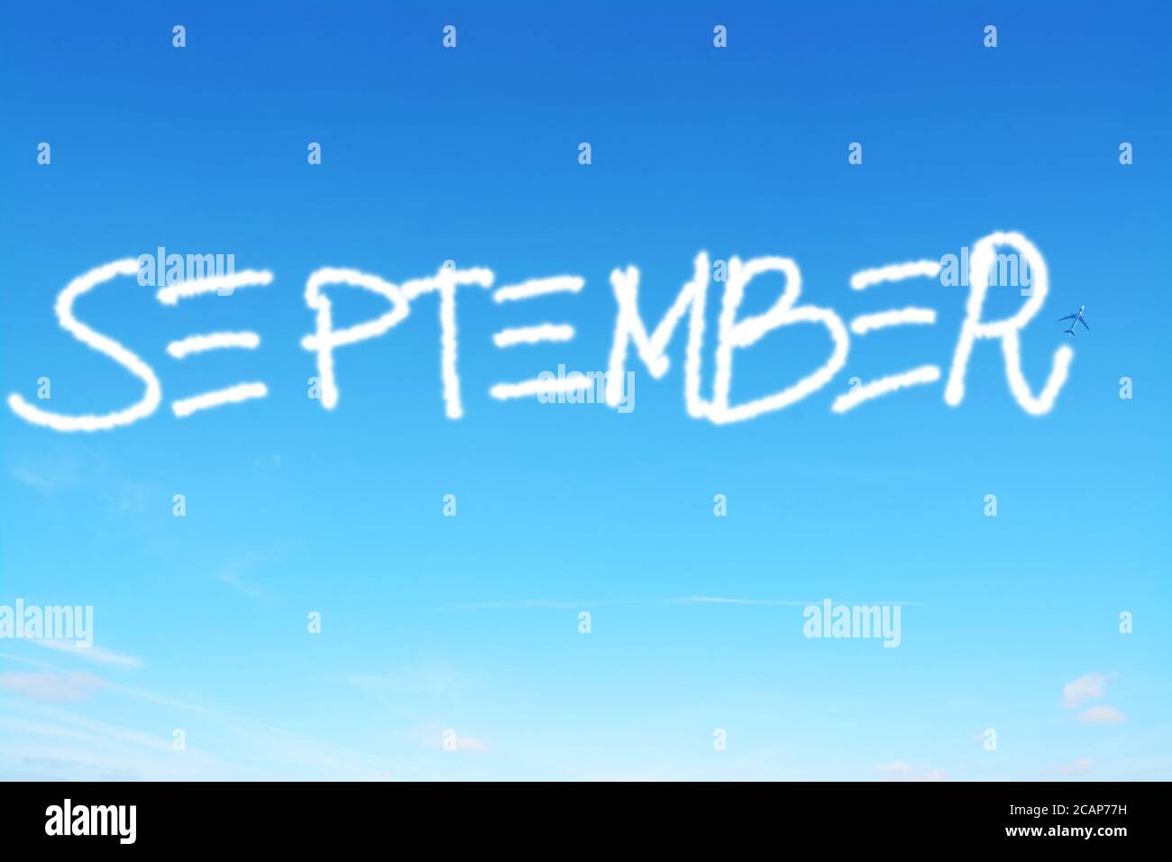 september written in the sky with contrails Stock Photo - Alamy