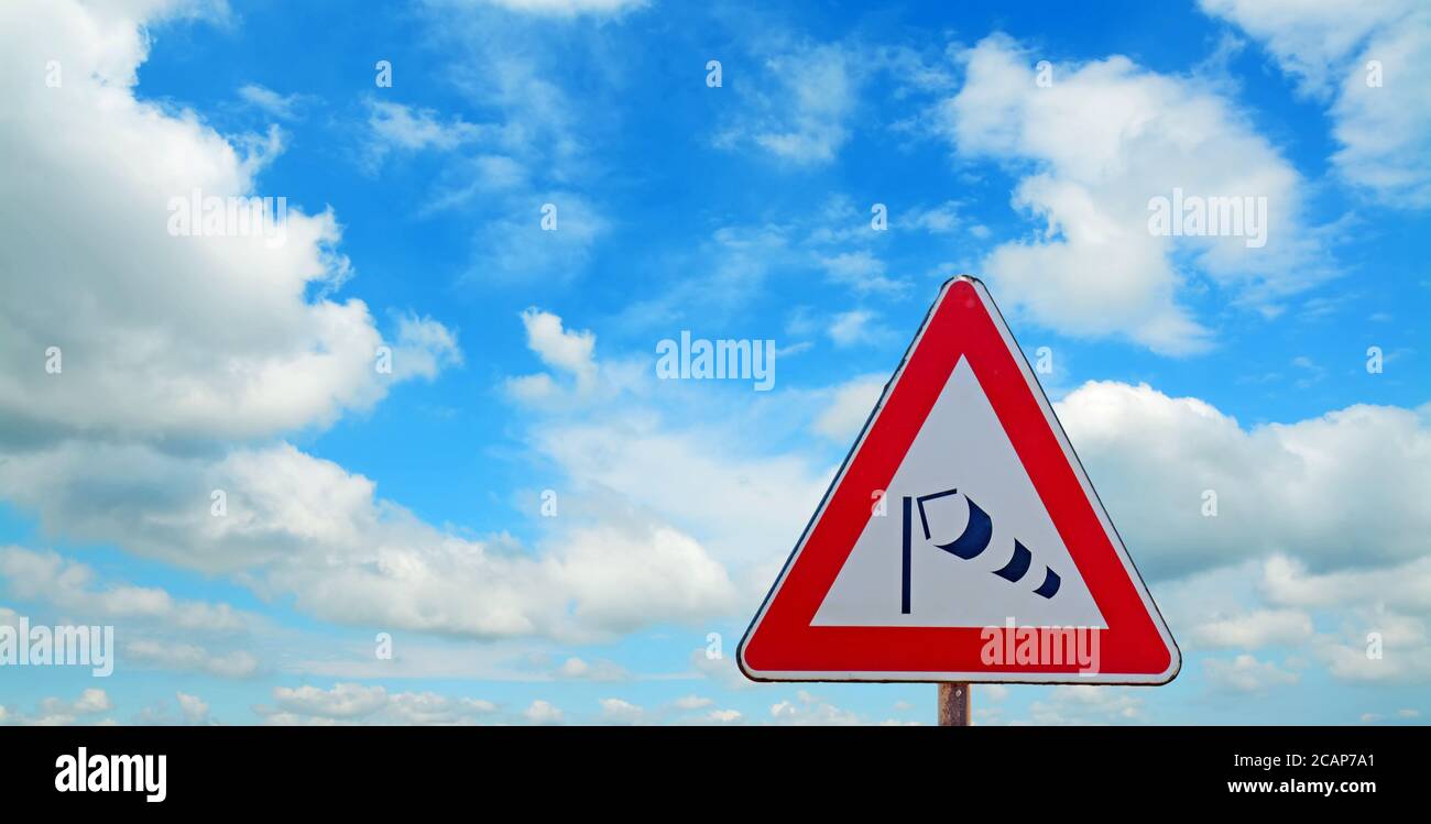 wind sock sign under a blue sky with clouds Stock Photo - Alamy