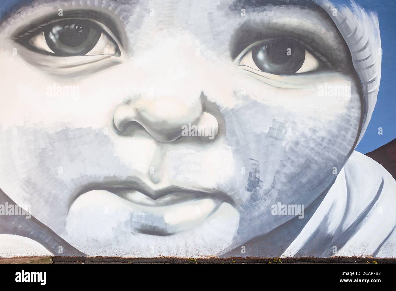 Graffiti artwork of young boy with head beanie balaclava large mural ...