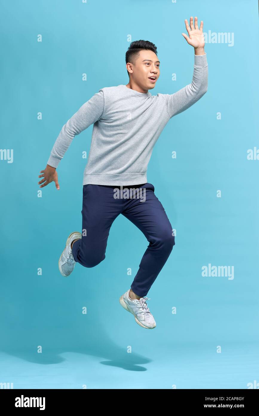 Full-length photo of funny man running or jumping in air isolated over ...