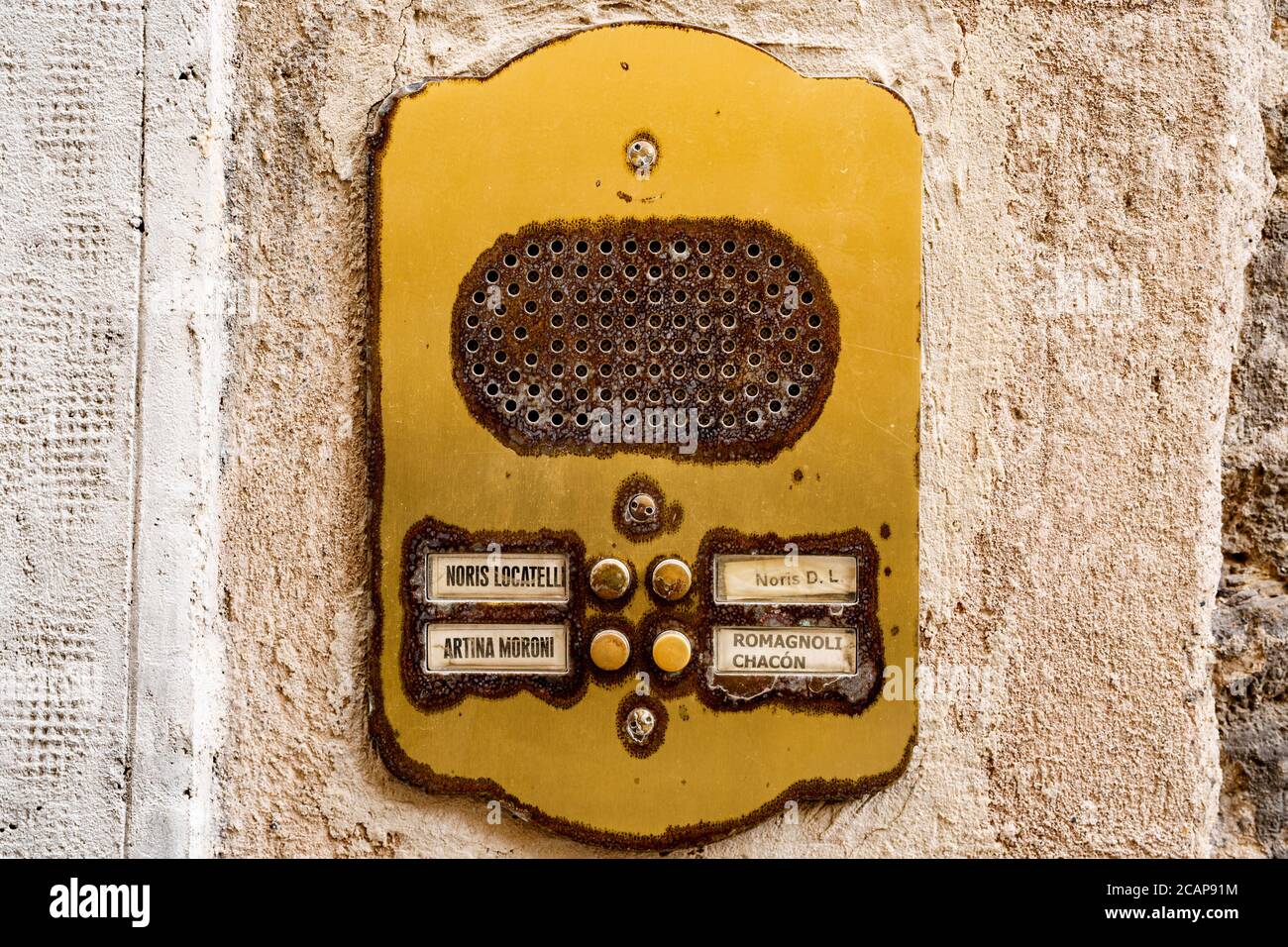 Antique yellow intercom for four apartments with names of subscribers ...