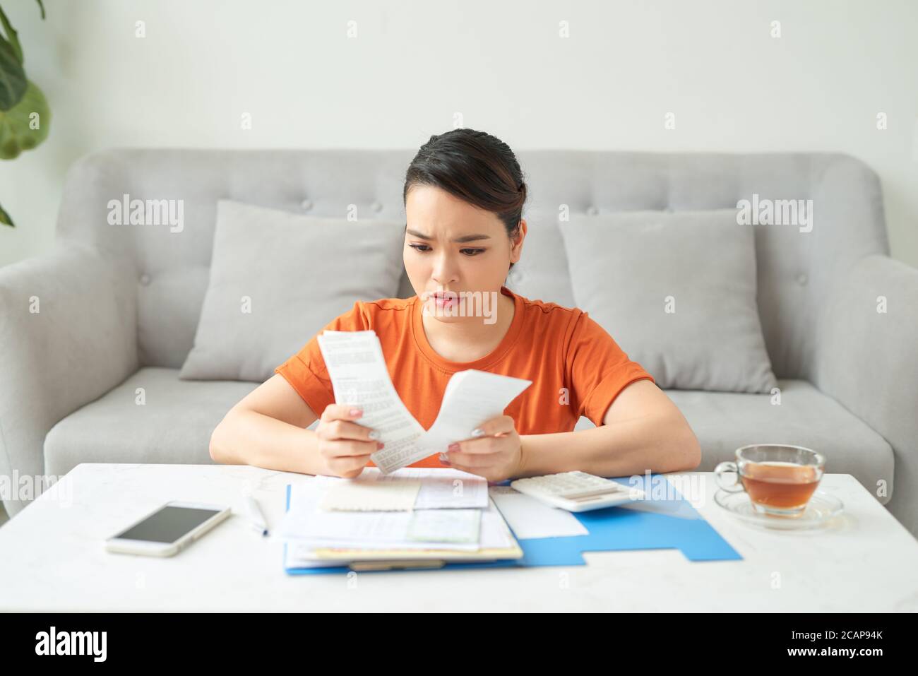young woman calculates monthly expenses Stock Photo - Alamy