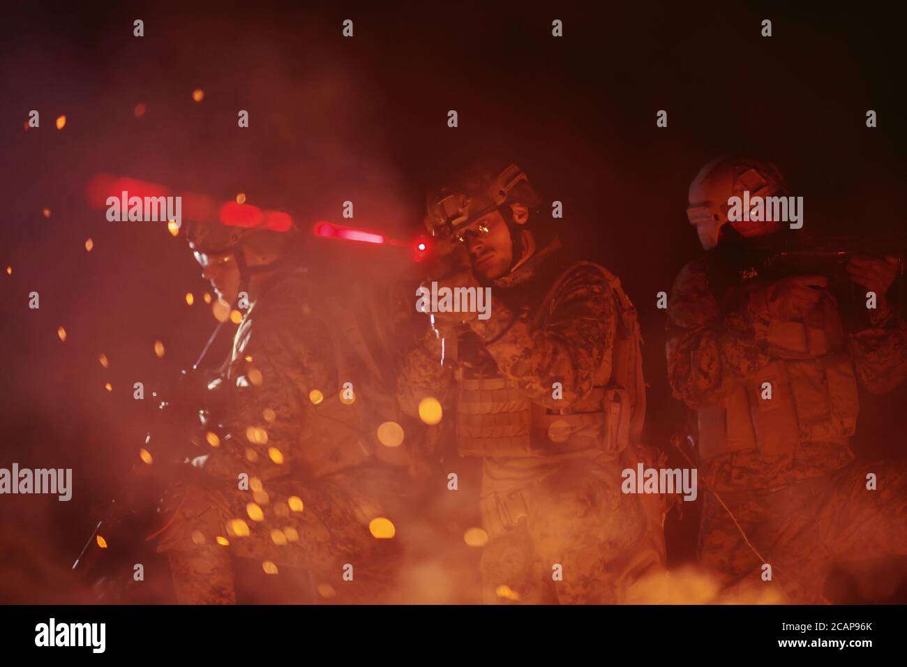 soldiers squad in action on night mission using laser sight beam lights ...