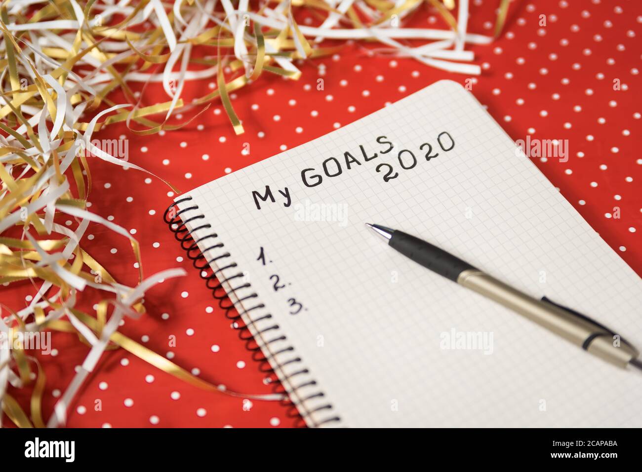 Phrase My Goals 2020 in a notebook, black pen. Red background and ...